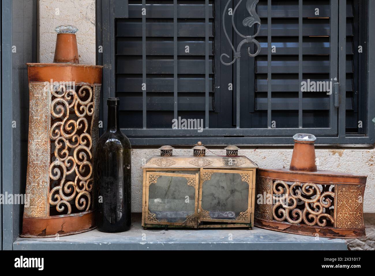 A broken down, dirty glass housing with brass doors for a Hanukkah ...