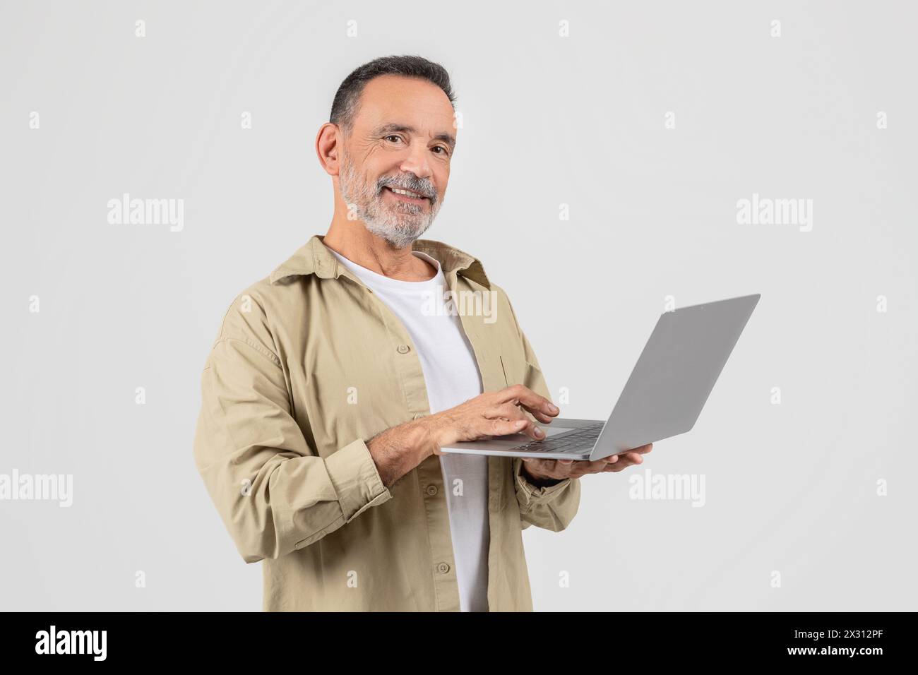 Man Holding Laptop Computer On White Background Stock Photo - Alamy