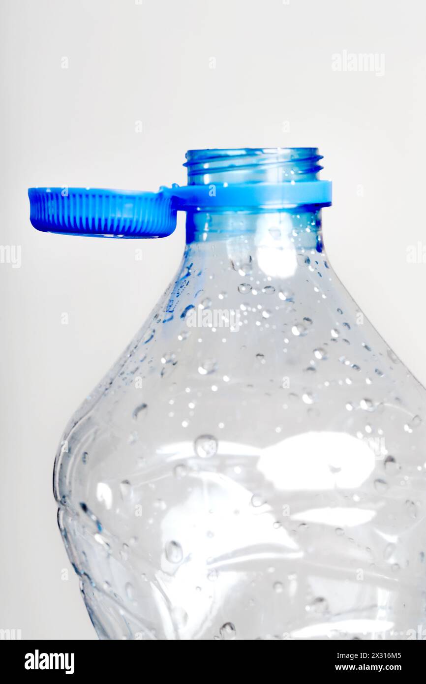 Close up of new cap attached to plastic bottle, connected to the neck ...