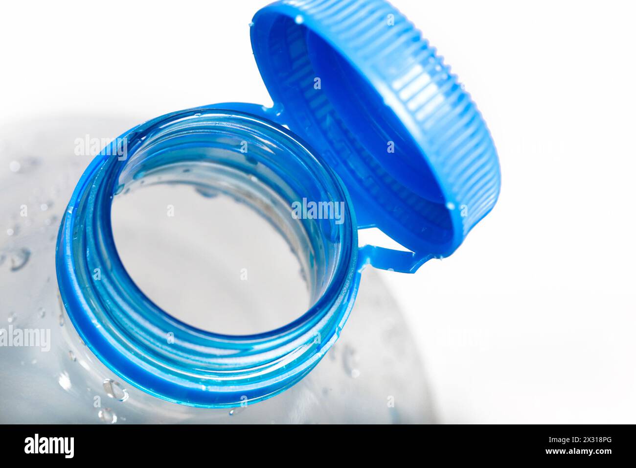 Close up of new cap attached to plastic bottle, connected to the neck ...