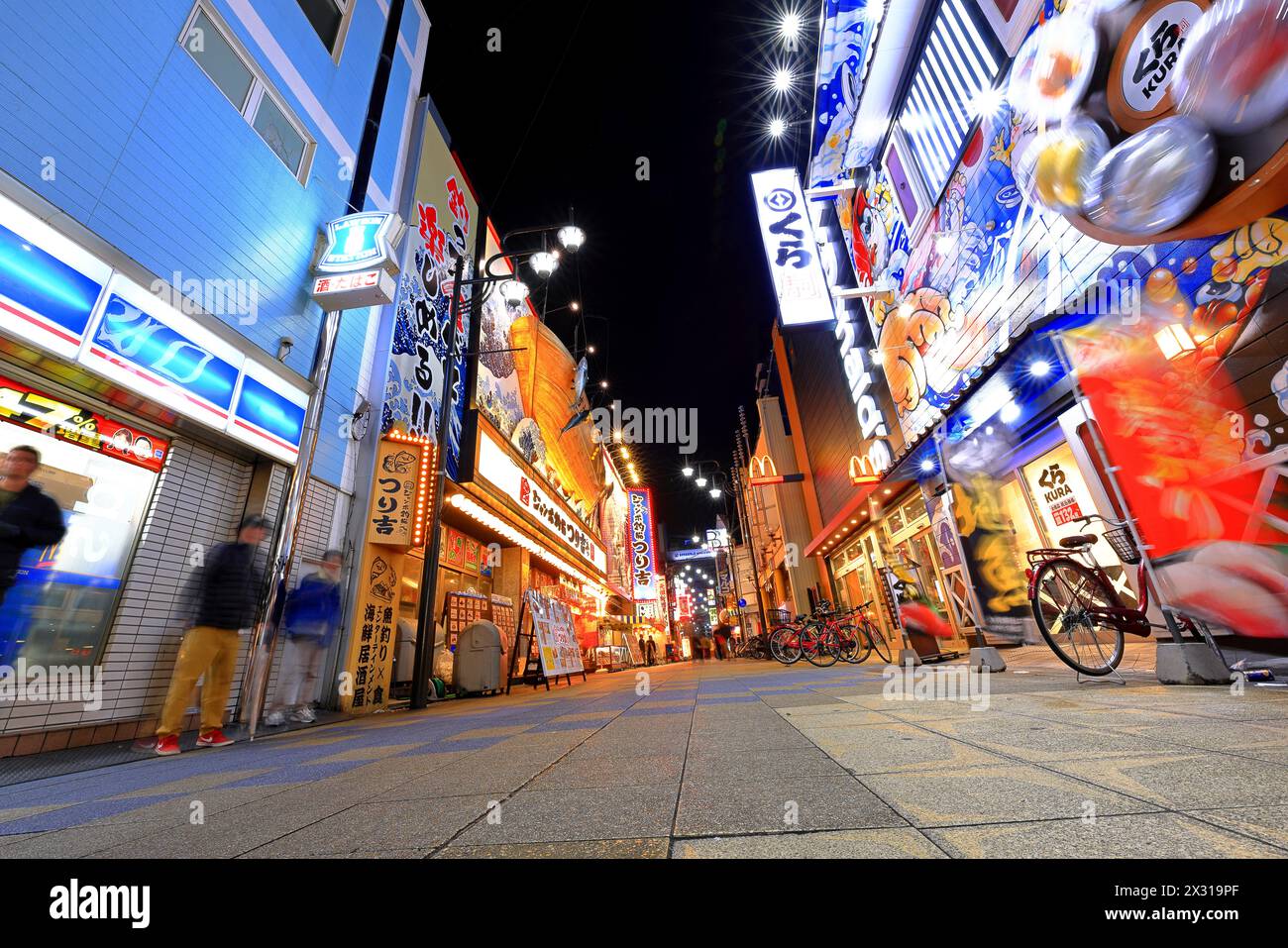 Night view with neon signs and illuminated billboards in Tsutenkaku ...