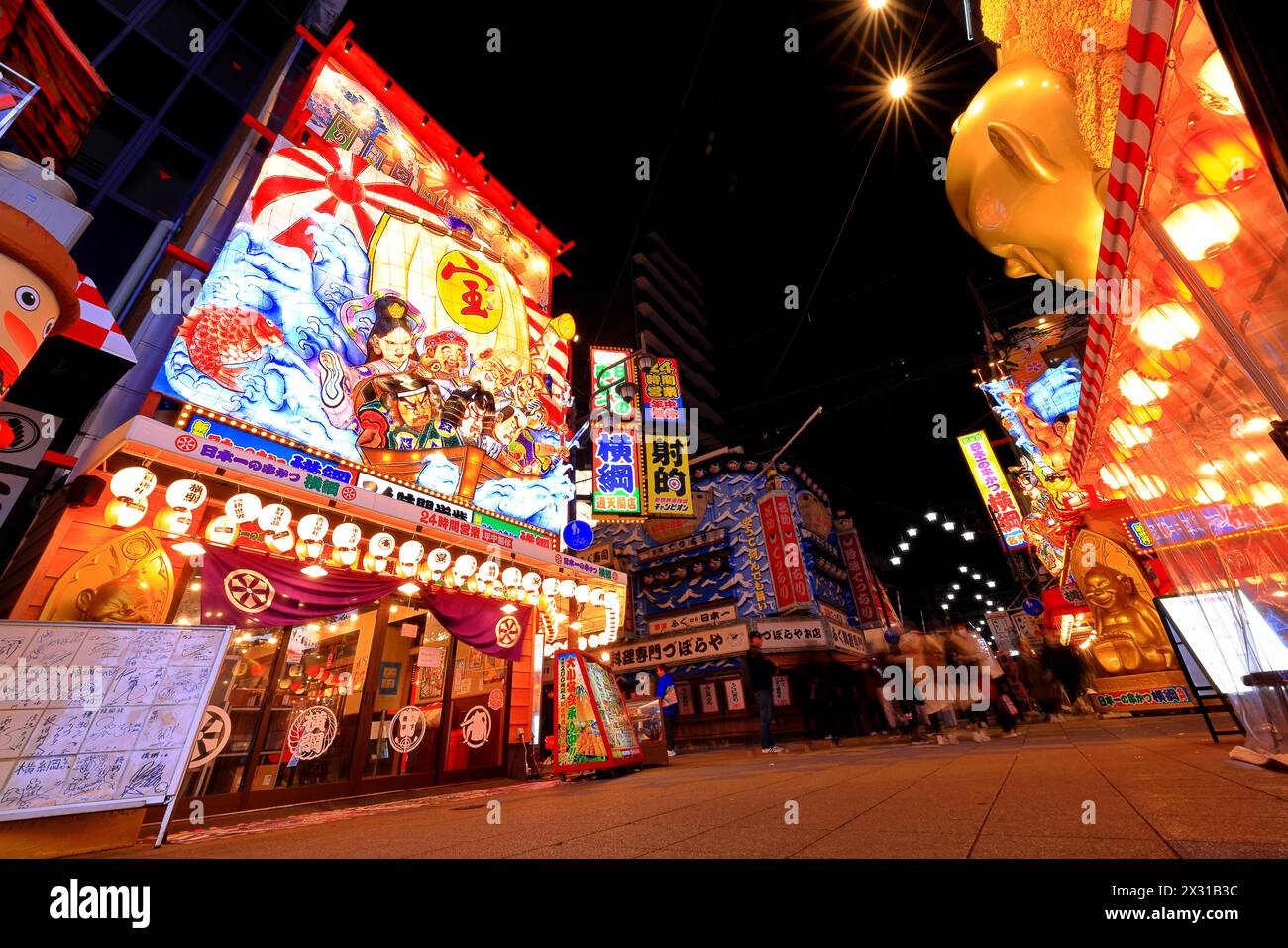 Night view with neon signs and illuminated billboards in Tsutenkaku ...