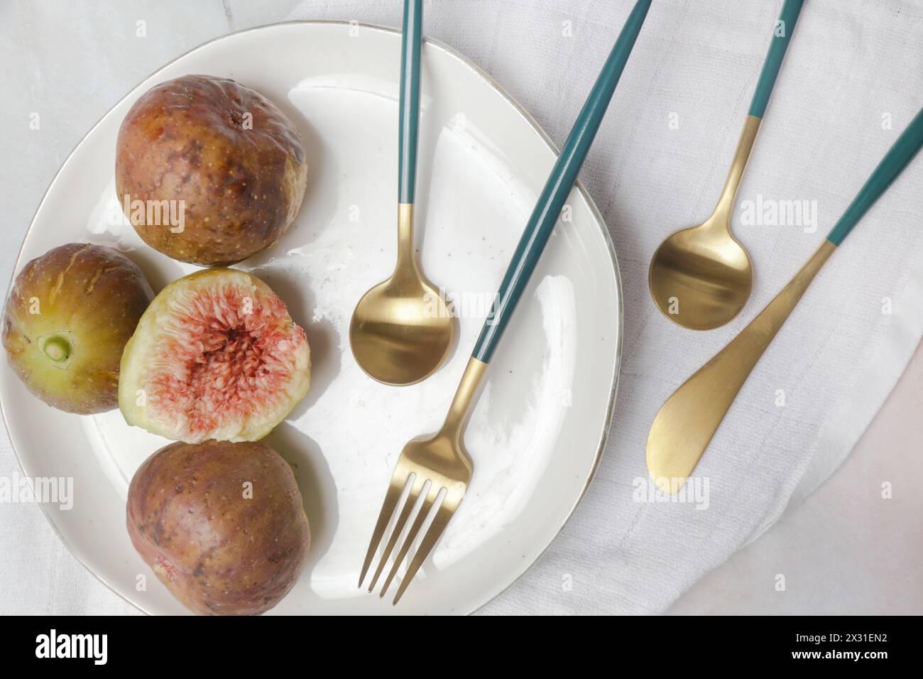 Creative shot of golden cutlery on marble table, Design concept. Modern ...