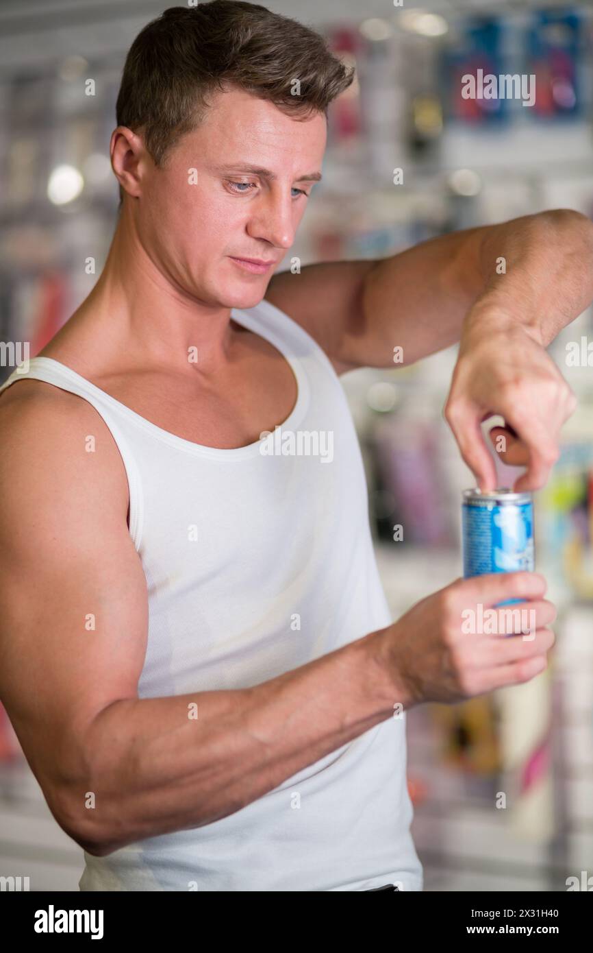 Muscular man opens a drink in a jar Stock Photo - Alamy