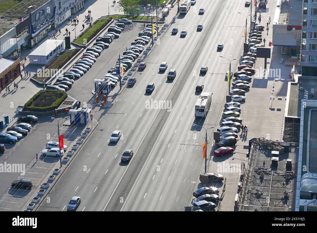Top view of riding and parked cars on city road at spring sunny day ...