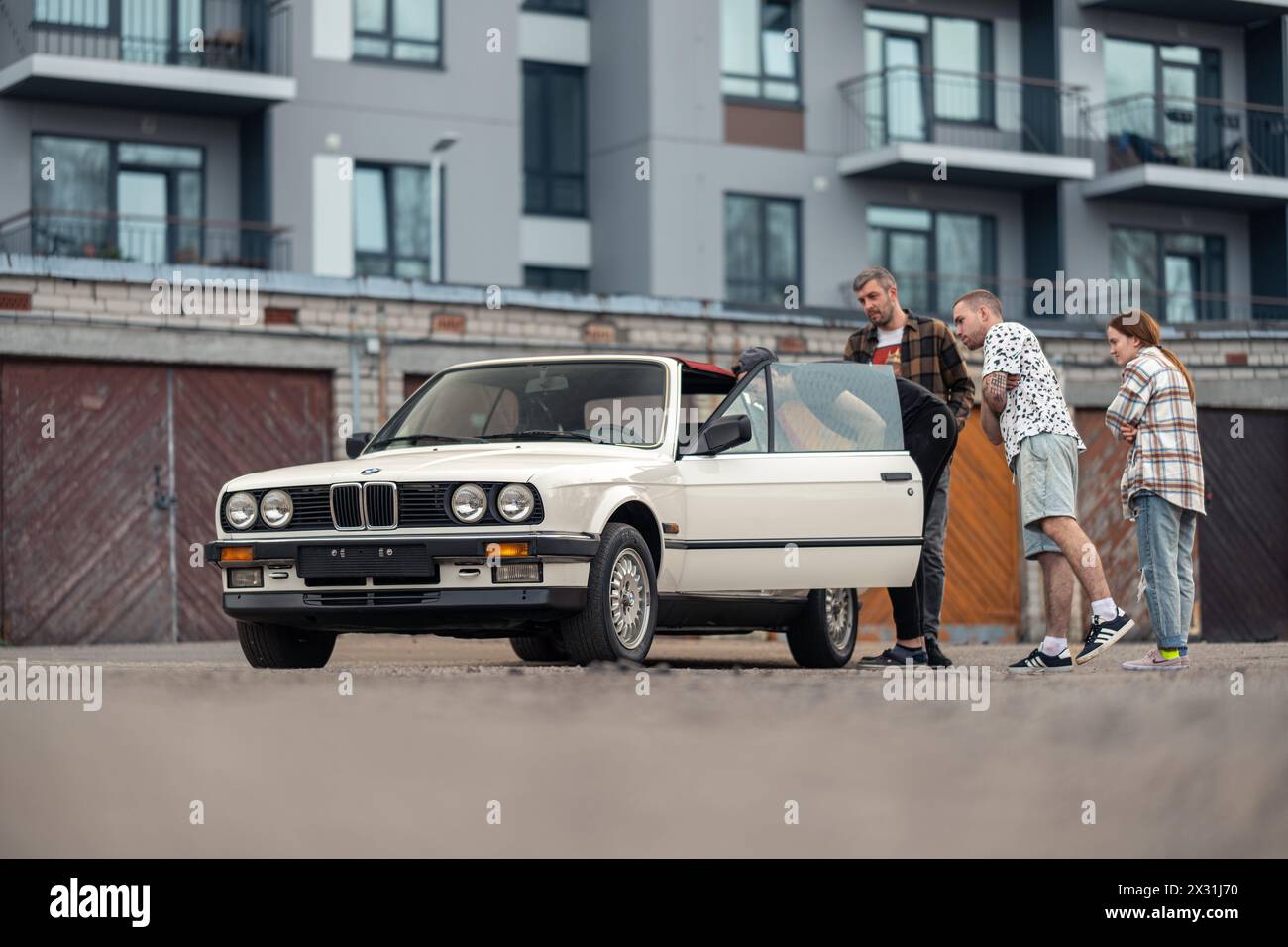Riga, Latvia - April 1, 2024: A group of young people looking with ...