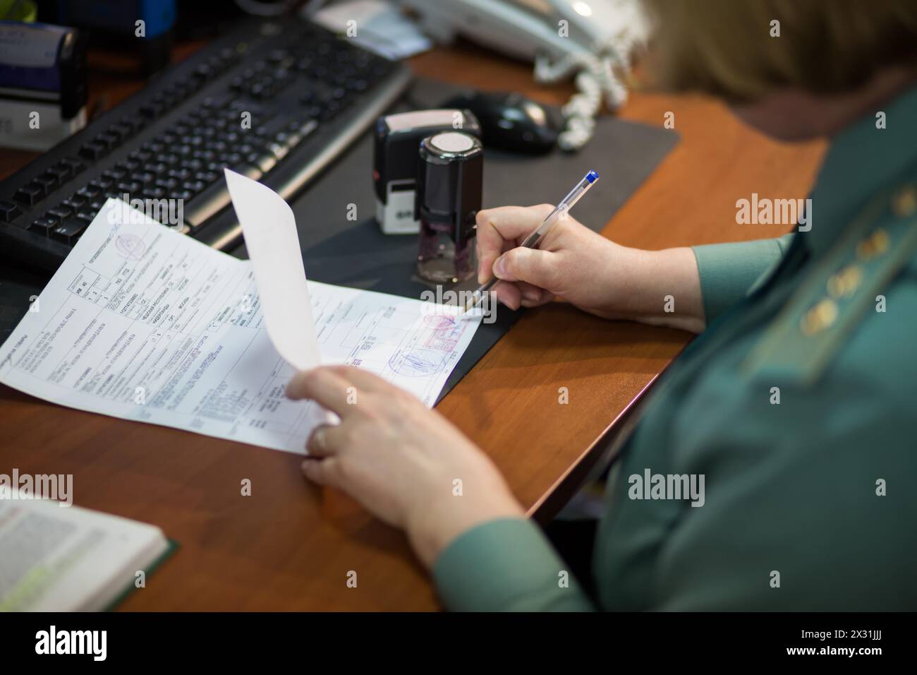 Woman signing customs form hi-res stock photography and images - Alamy