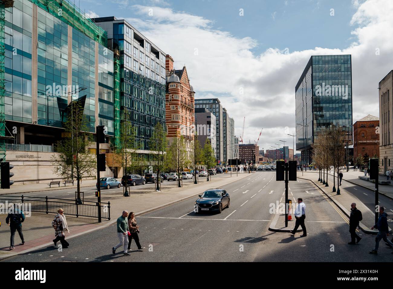 Liverpool, UK, April 11 2024: People cross The Strand street, near the ...