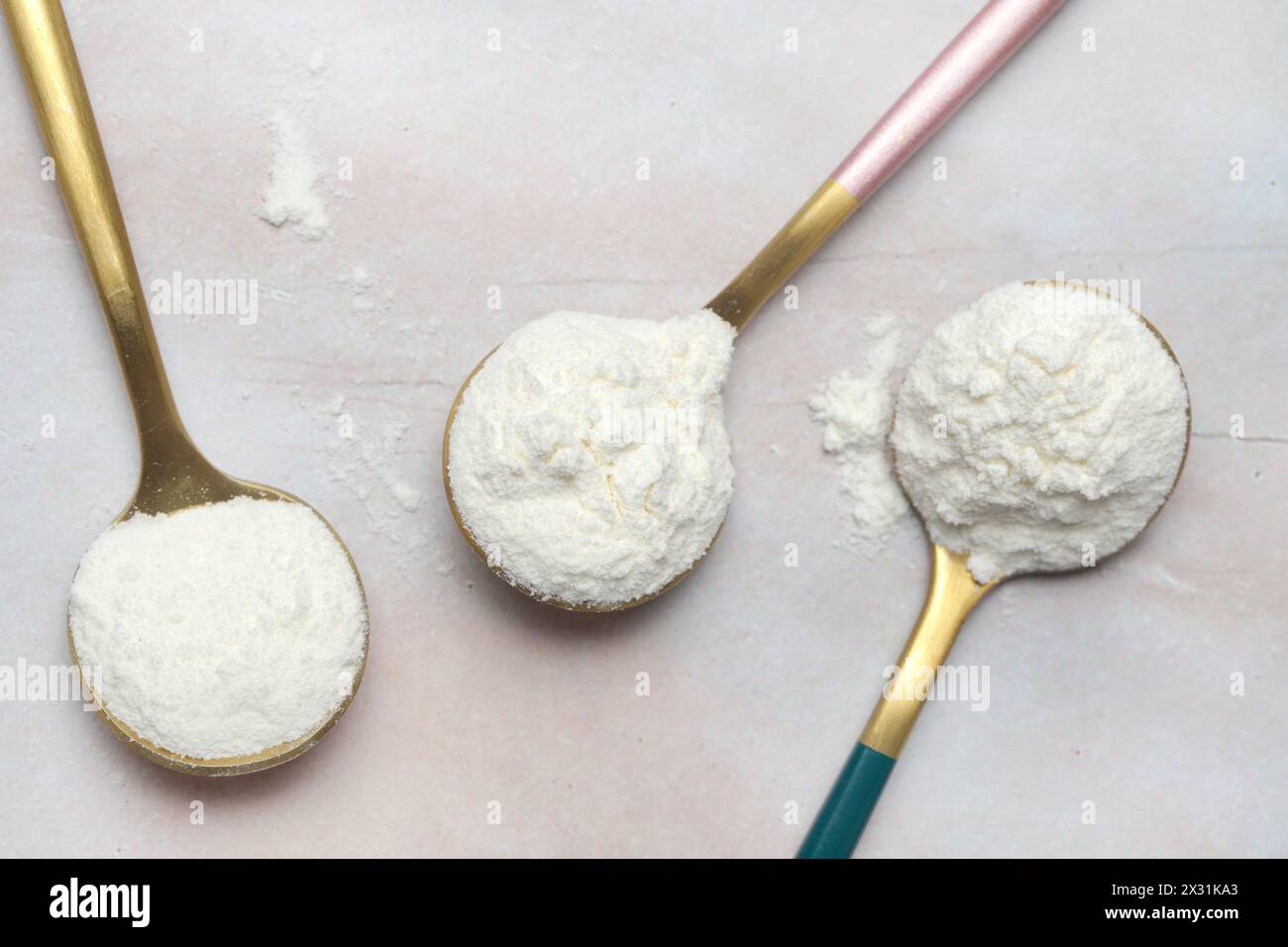 White powder in the spoon. Collagen protein powder or wheat flour ...