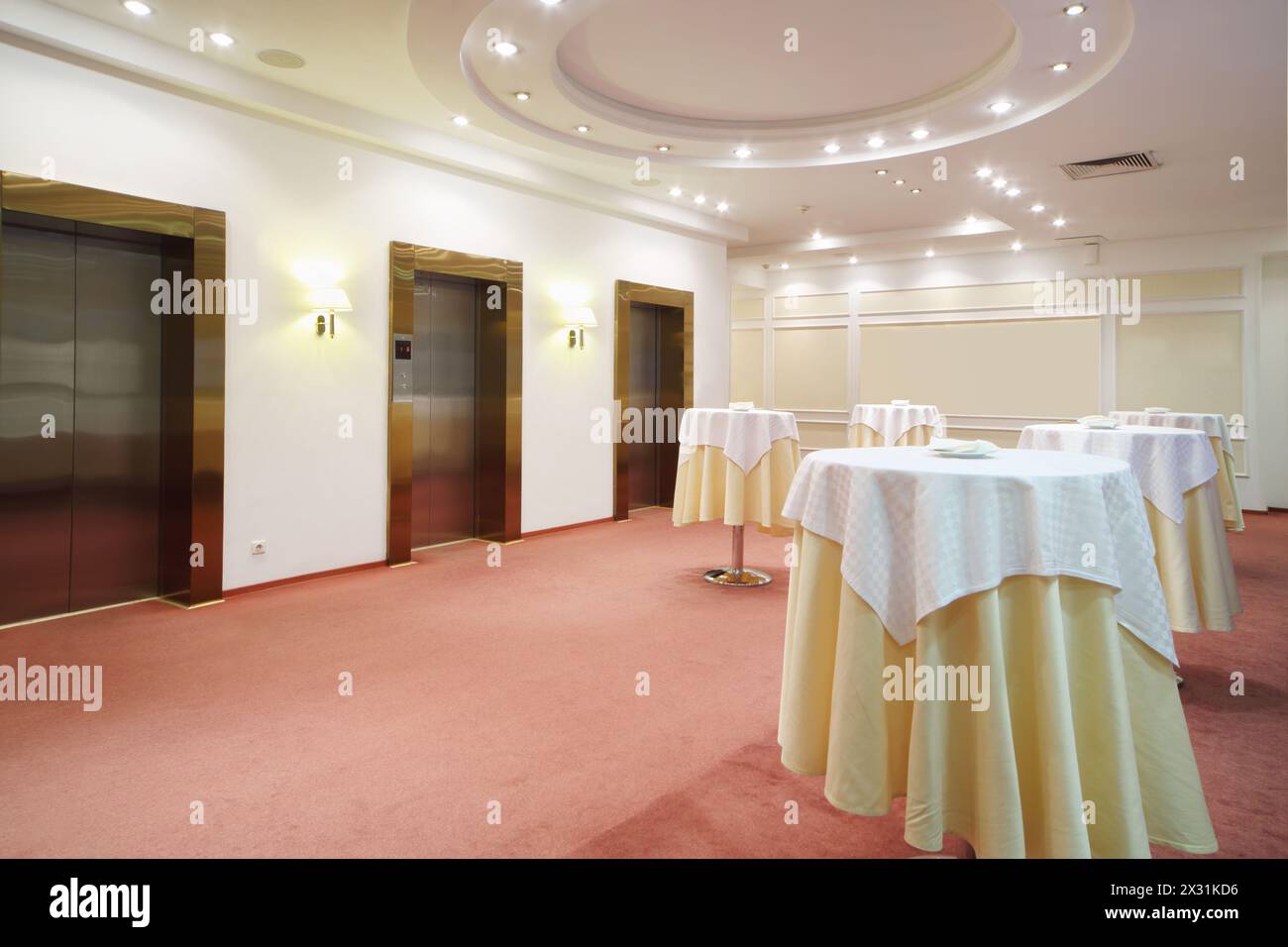 Round tables in light buffet at hotel and metal elevator doors Stock ...