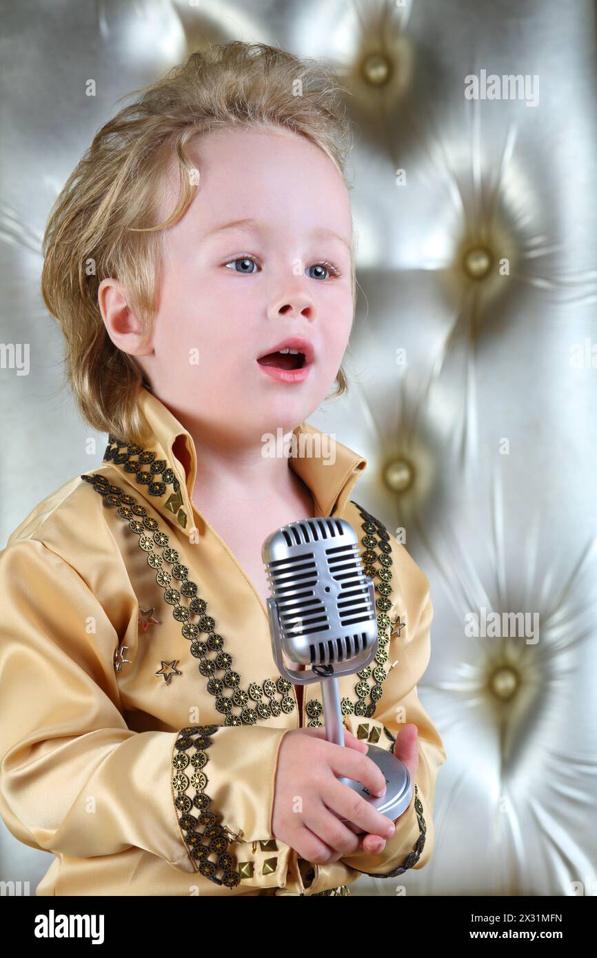 Portrait of a little boy in pop retro suit sings a song Stock Photo - Alamy