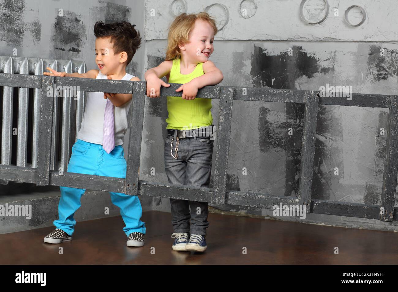 Two happy boys carry wooden staircase Stock Photo - Alamy