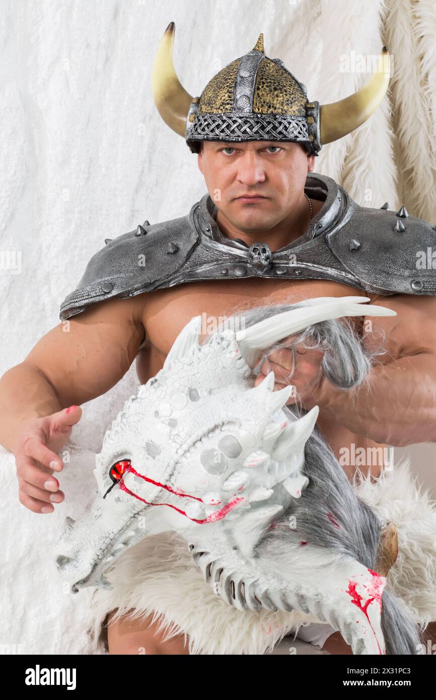 A muscular man in costume viking with a dragons head Stock Photo - Alamy