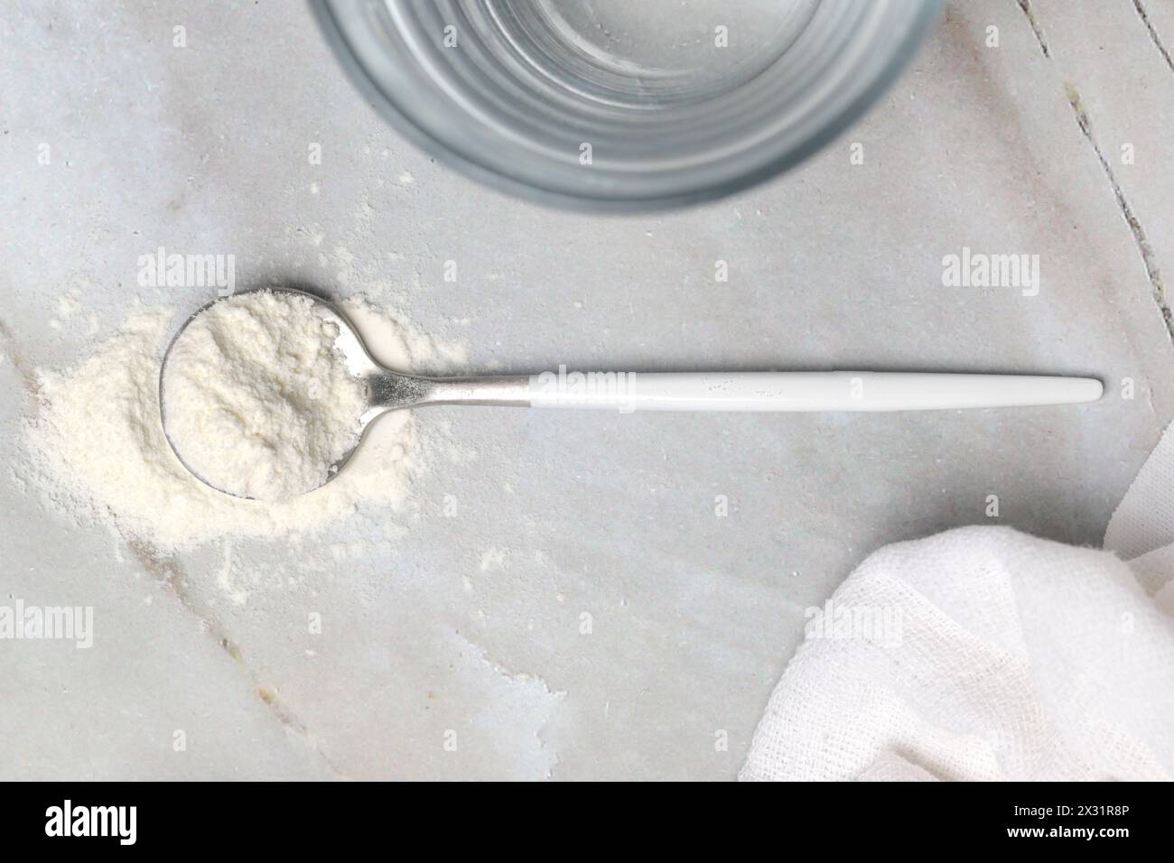 White powder in the spoon. Collagen protein powder or wheat flour ...