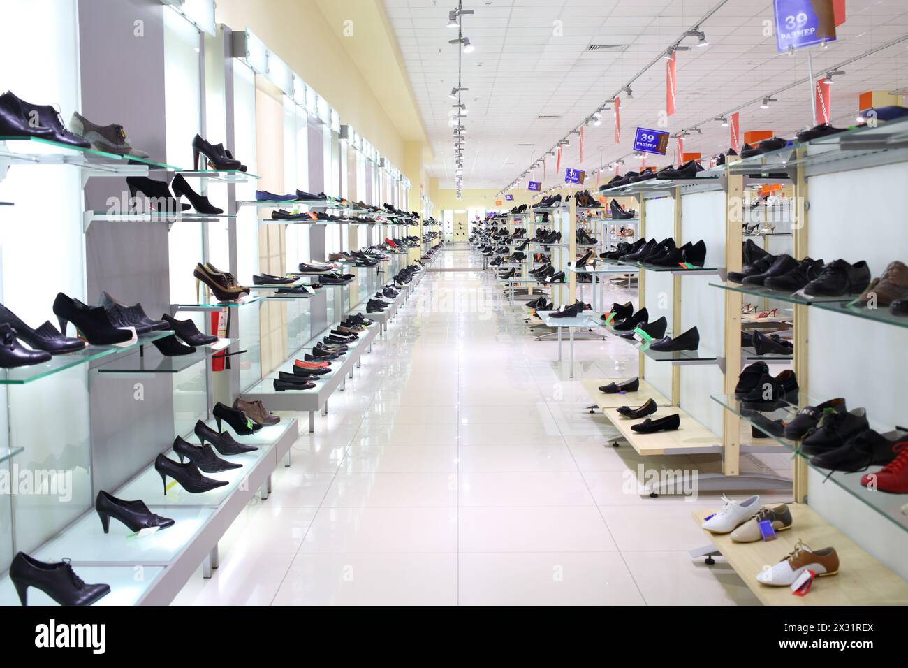 SAMARA, RUSSIA - JULY 7: A lot of womens shoes on a glass shelf in a ...