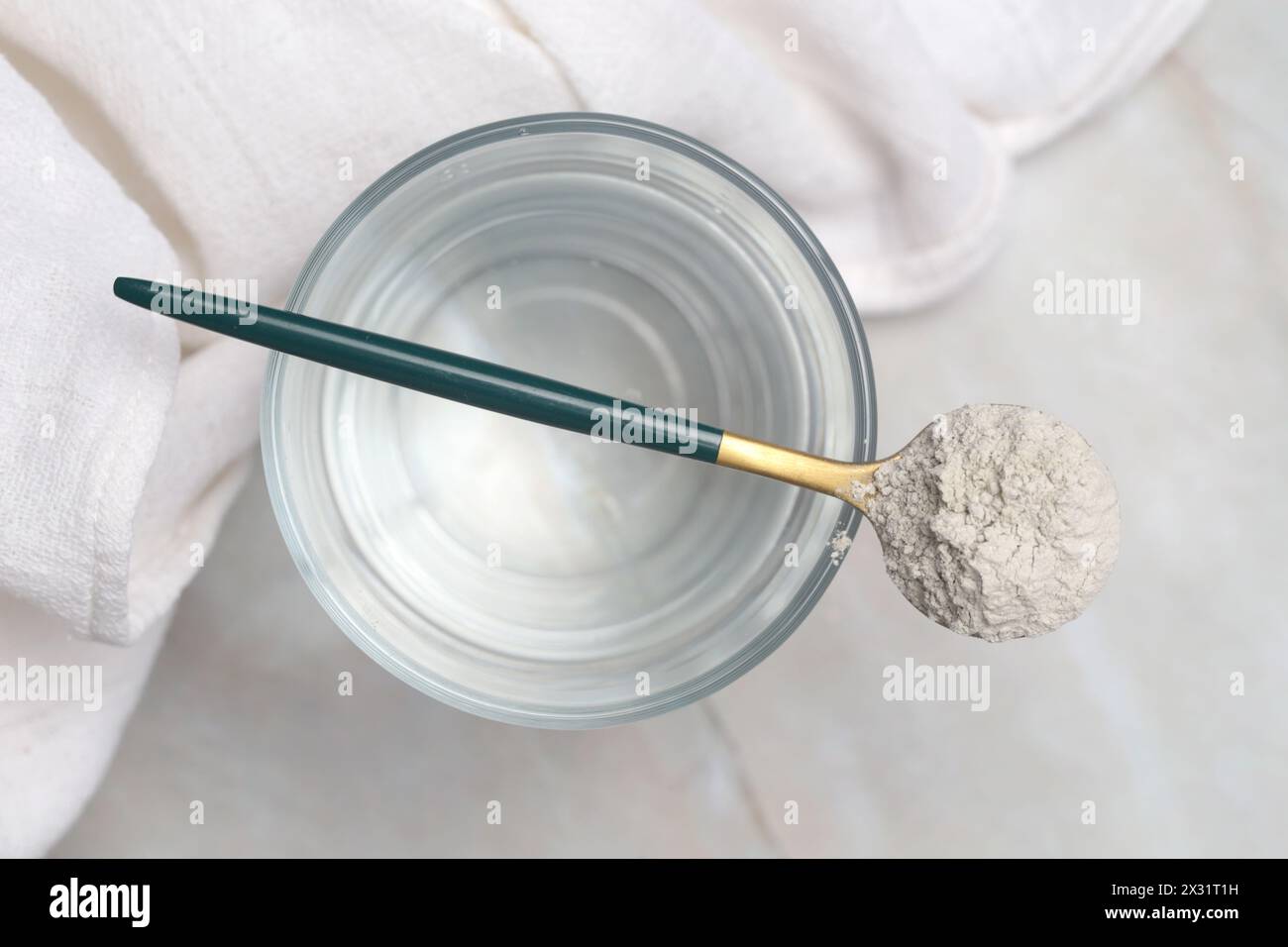 White powder in the spoon. Collagen protein powder or wheat flour ...