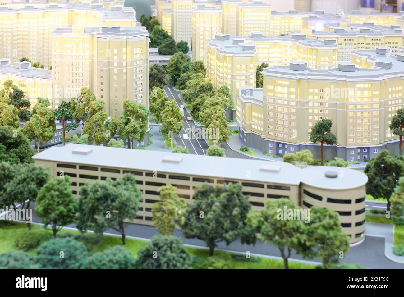 Small layout of yellow high-rise residential buildings, trees and road ...