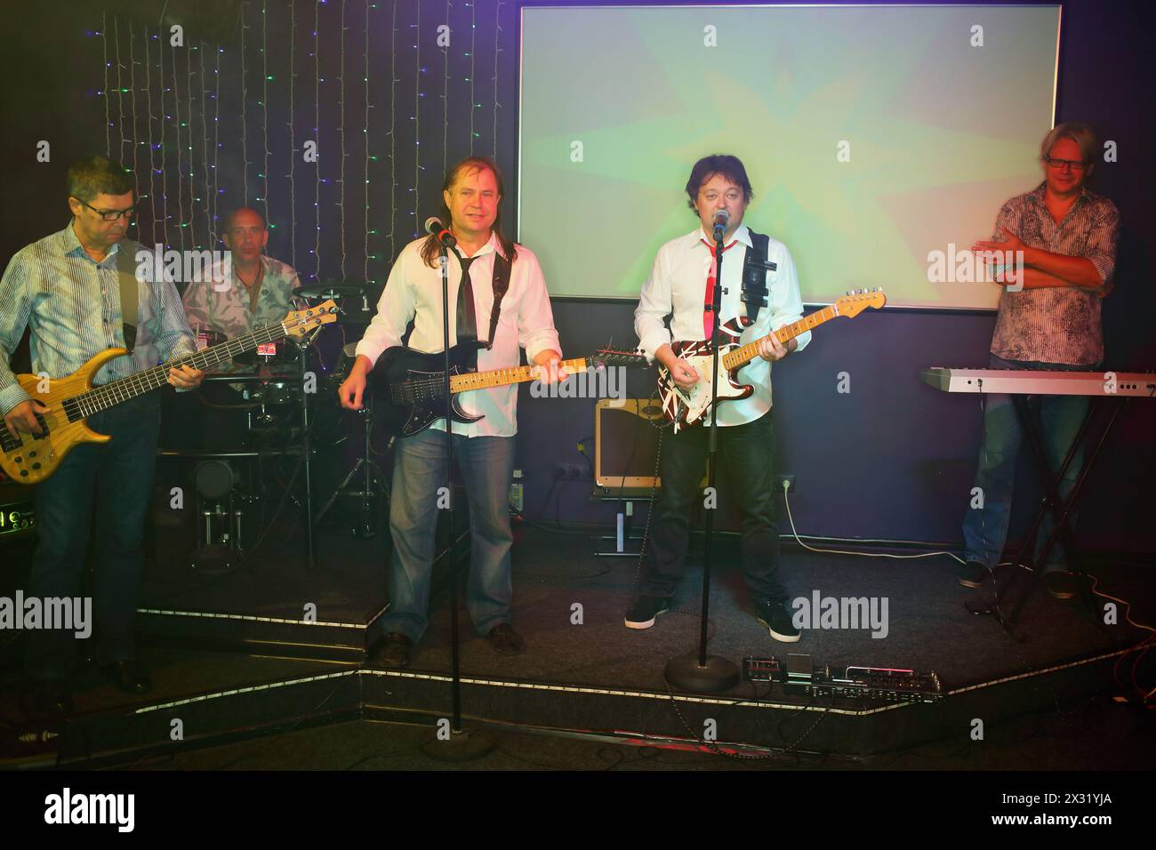 Five men with musical instruments performs on stage in a club Stock ...