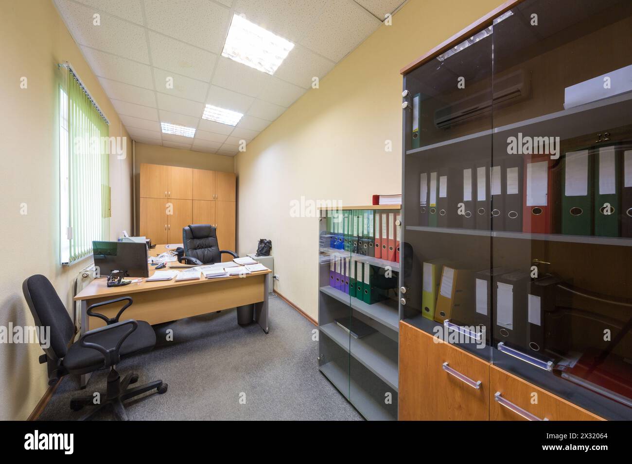 Comfortable office room with bookshelf and folders Stock Photo - Alamy