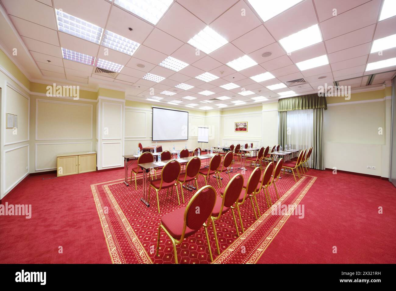 Back of red chairs with tables in room in classical style for business ...