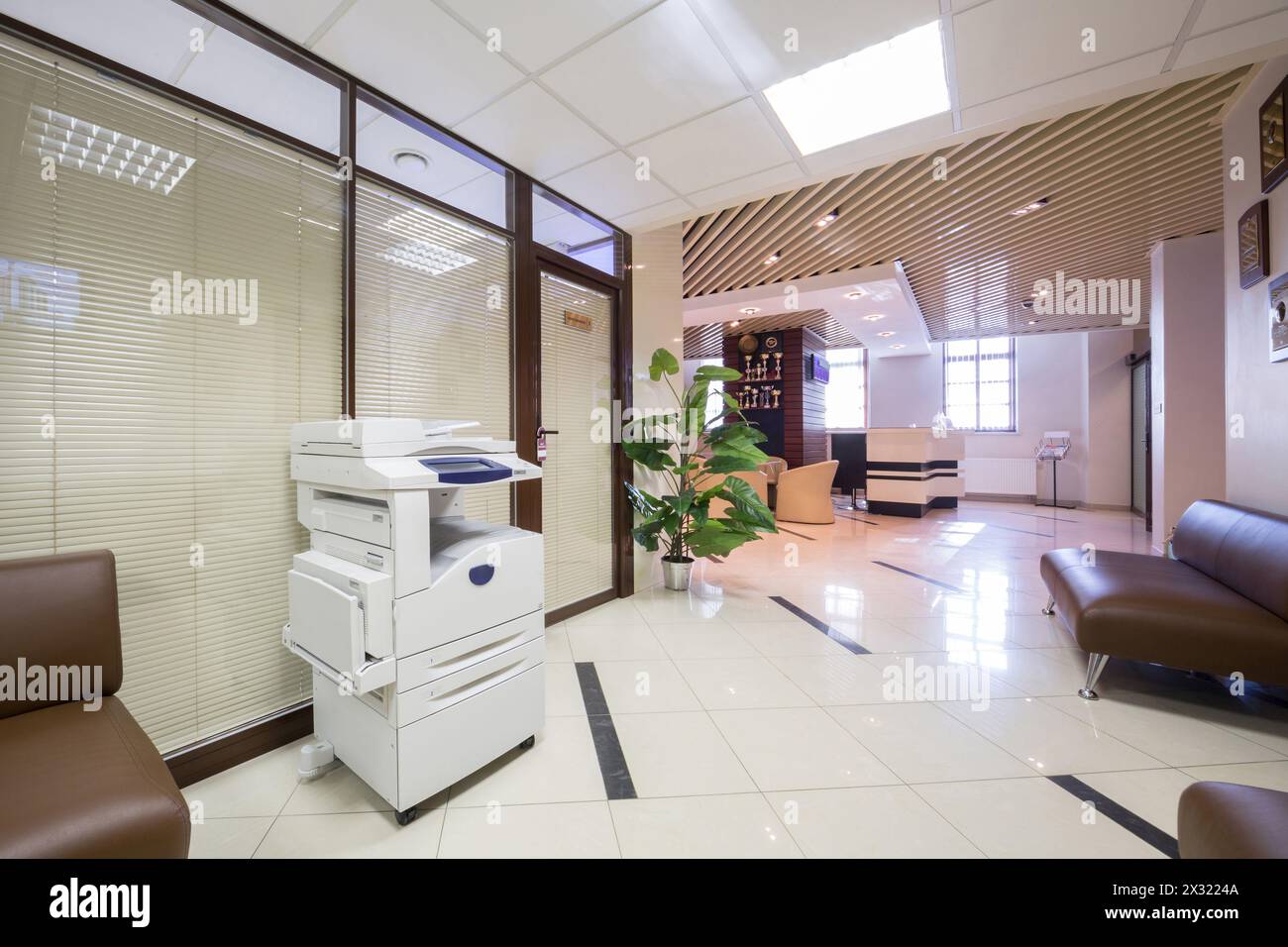 Large corridor near reception in business company with sofas and chairs ...