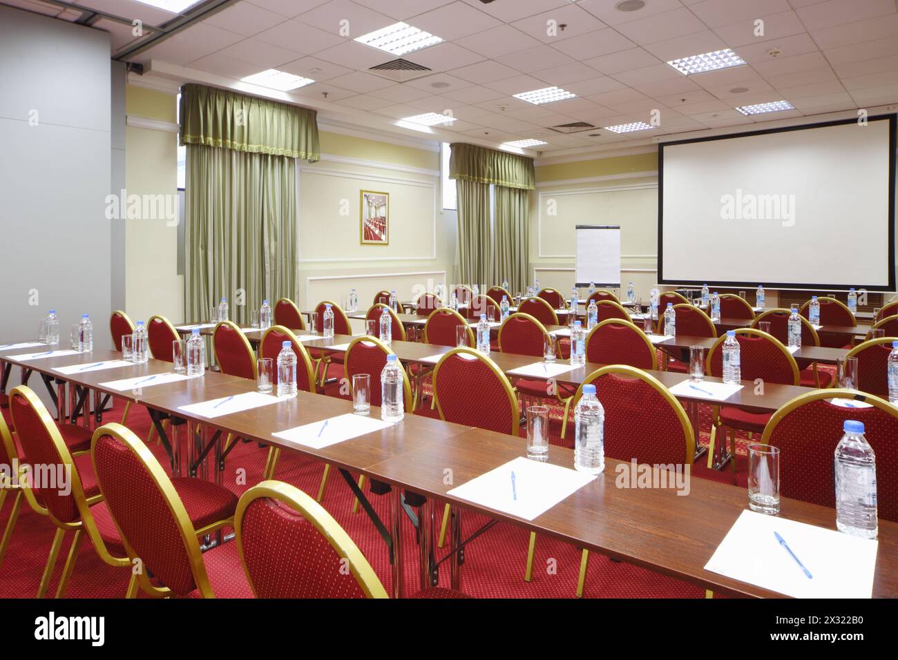 Back of red chairs and wooden tables in stylish room for business ...