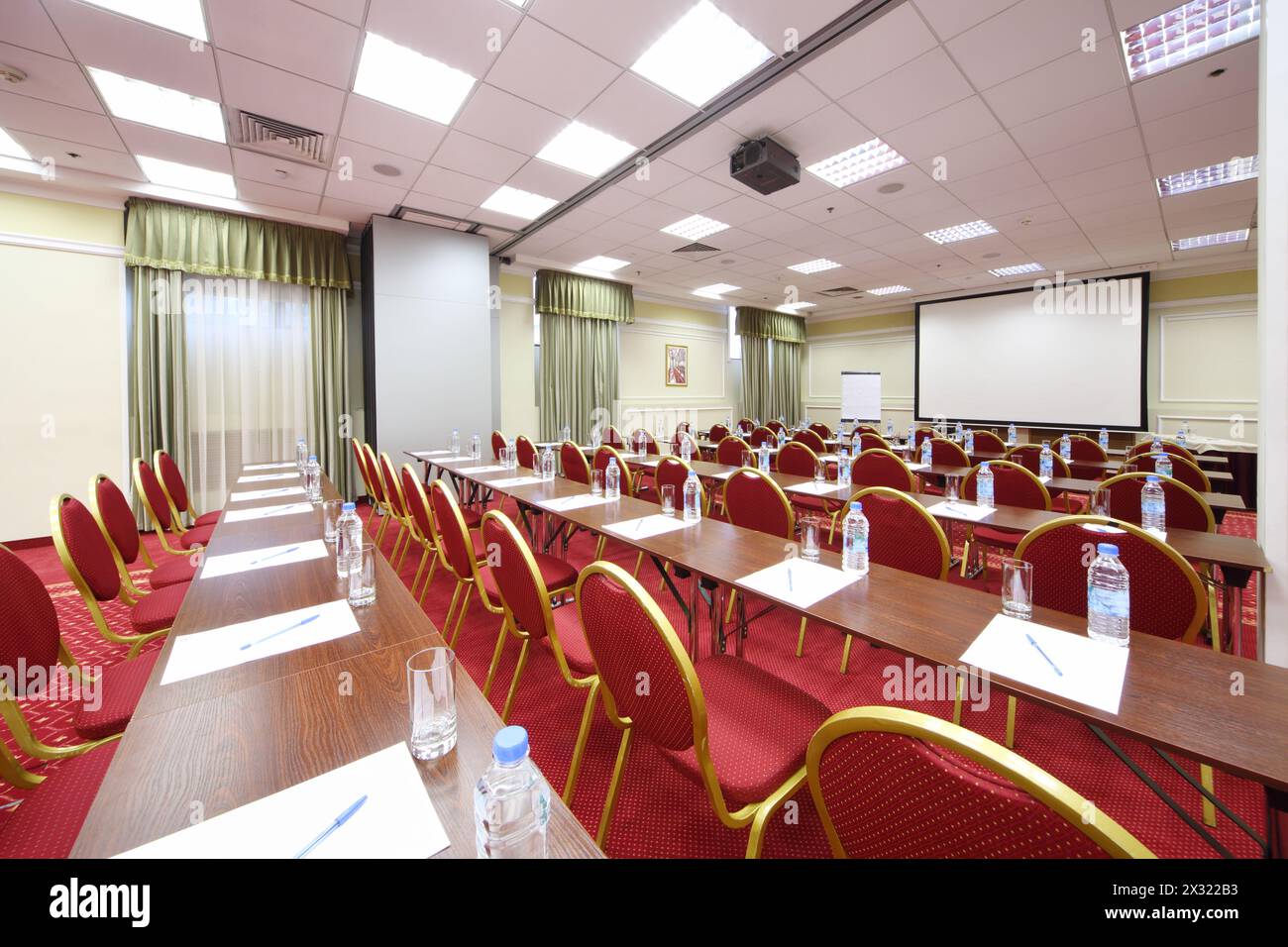 Back of red chairs and wooden tables in empty room for business ...