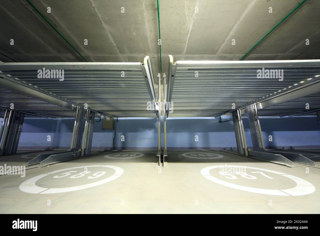 Electrolifts inside indoor two-level parking with numbers on floor for ...