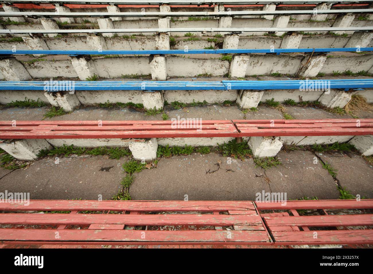 Long dirty destroyed blue and red grandstands at old stadium Stock ...