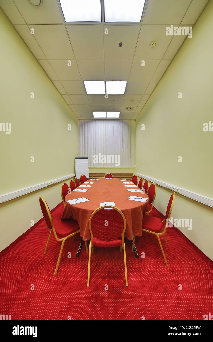 Chairs and table in modern empty conference room with a red carpet on ...