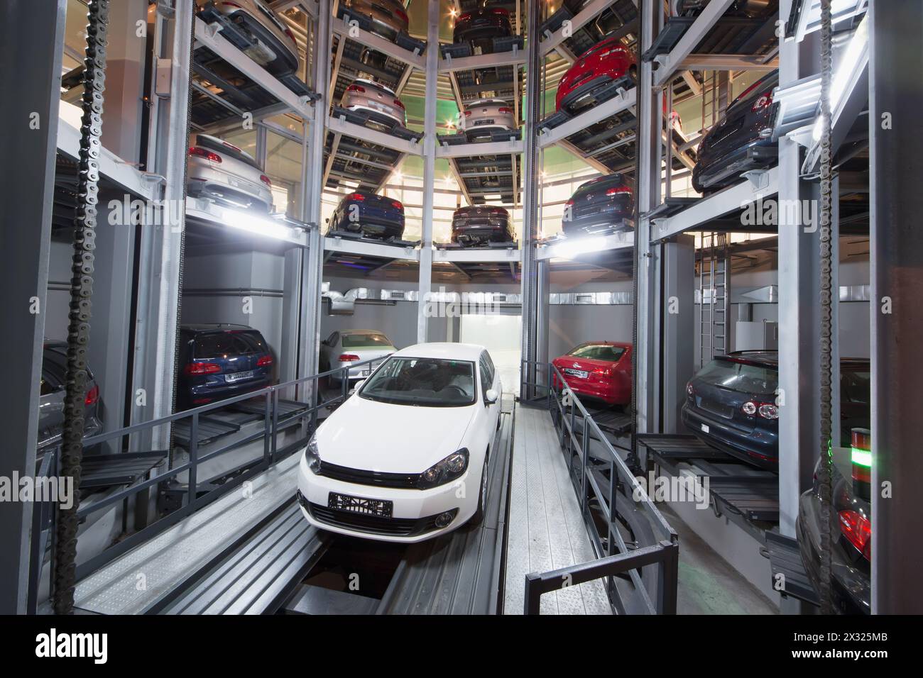 The car on lift in premises for storage cars in Center at night. The ...