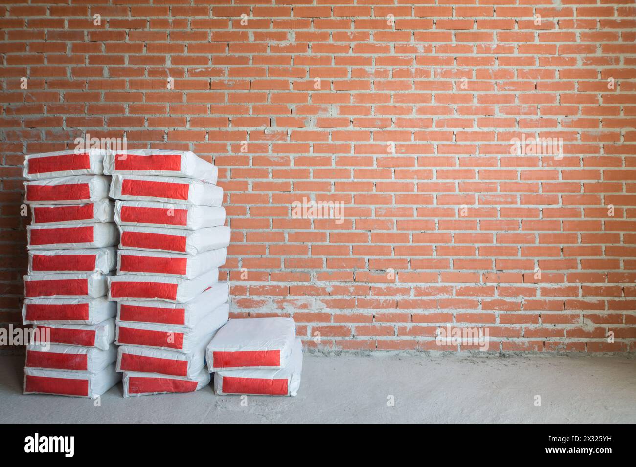 Bags of plaster next to a brick wall in the new apartment Stock Photo ...