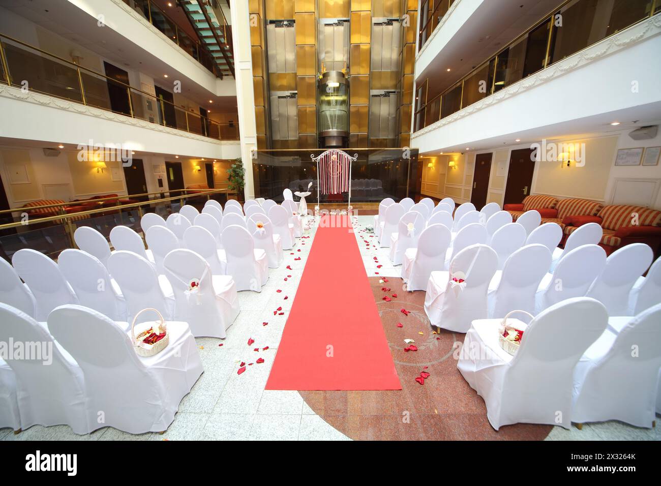 A beautiful empty hall for a wedding ceremony with flower petals on the ...