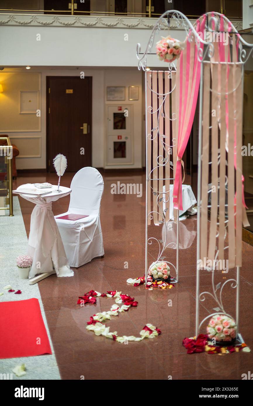 Empty hall for a wedding ceremony with a table for signatures and arch ...