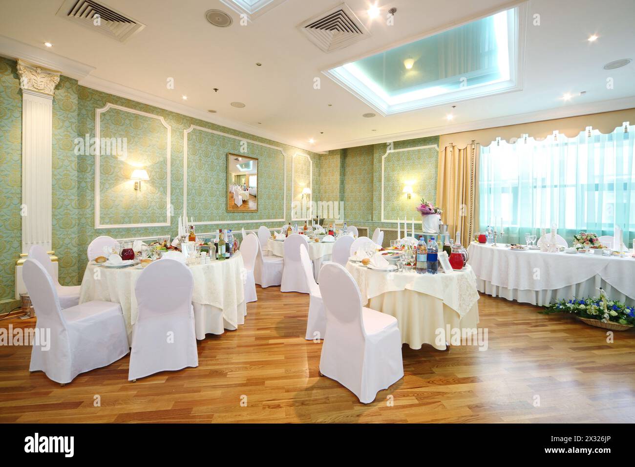 Hall with tables and chairs in a restaurant decorated for a wedding ...