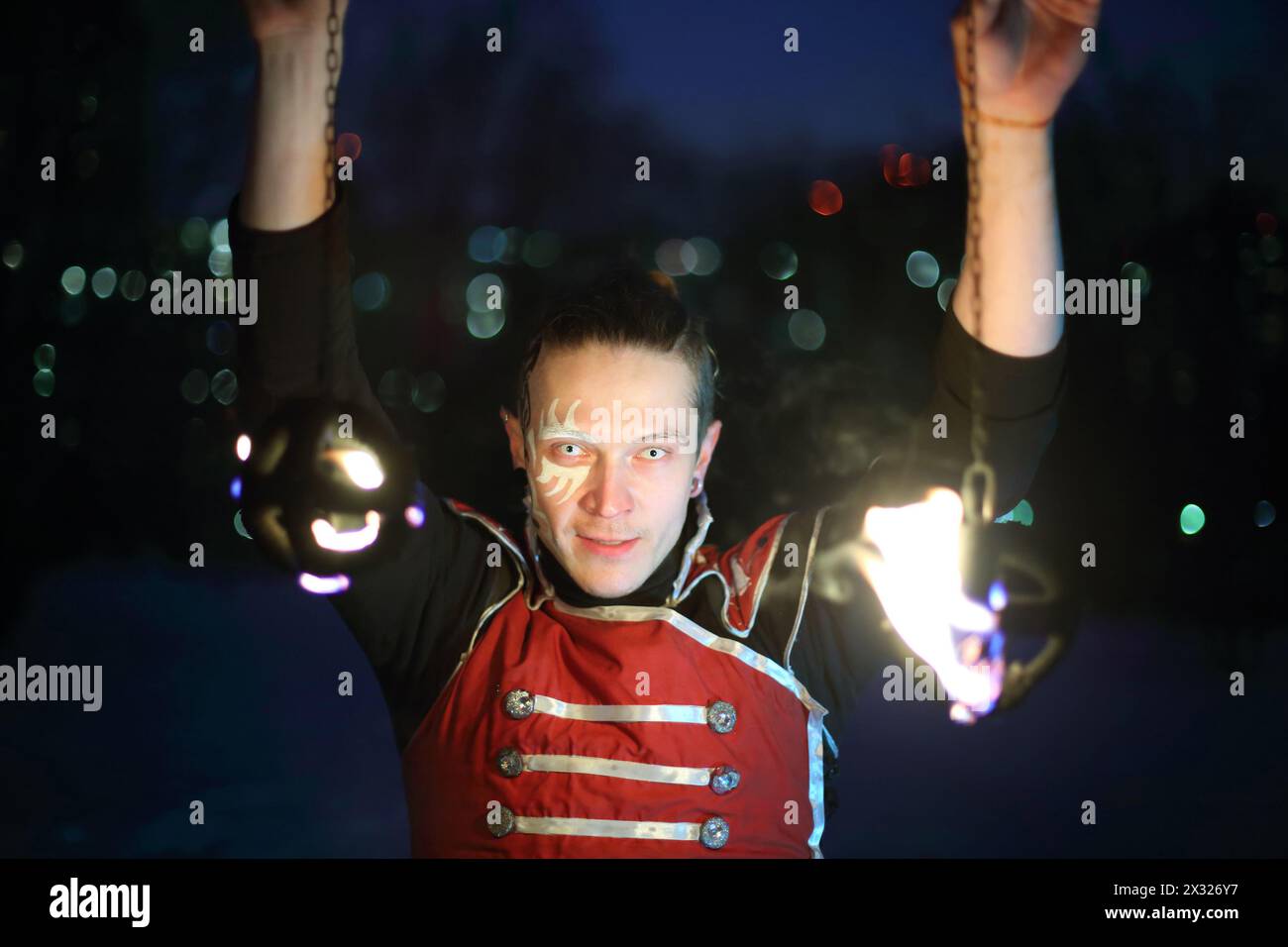 Performance of a man with a terrible pupils in samurai garb with fire ...