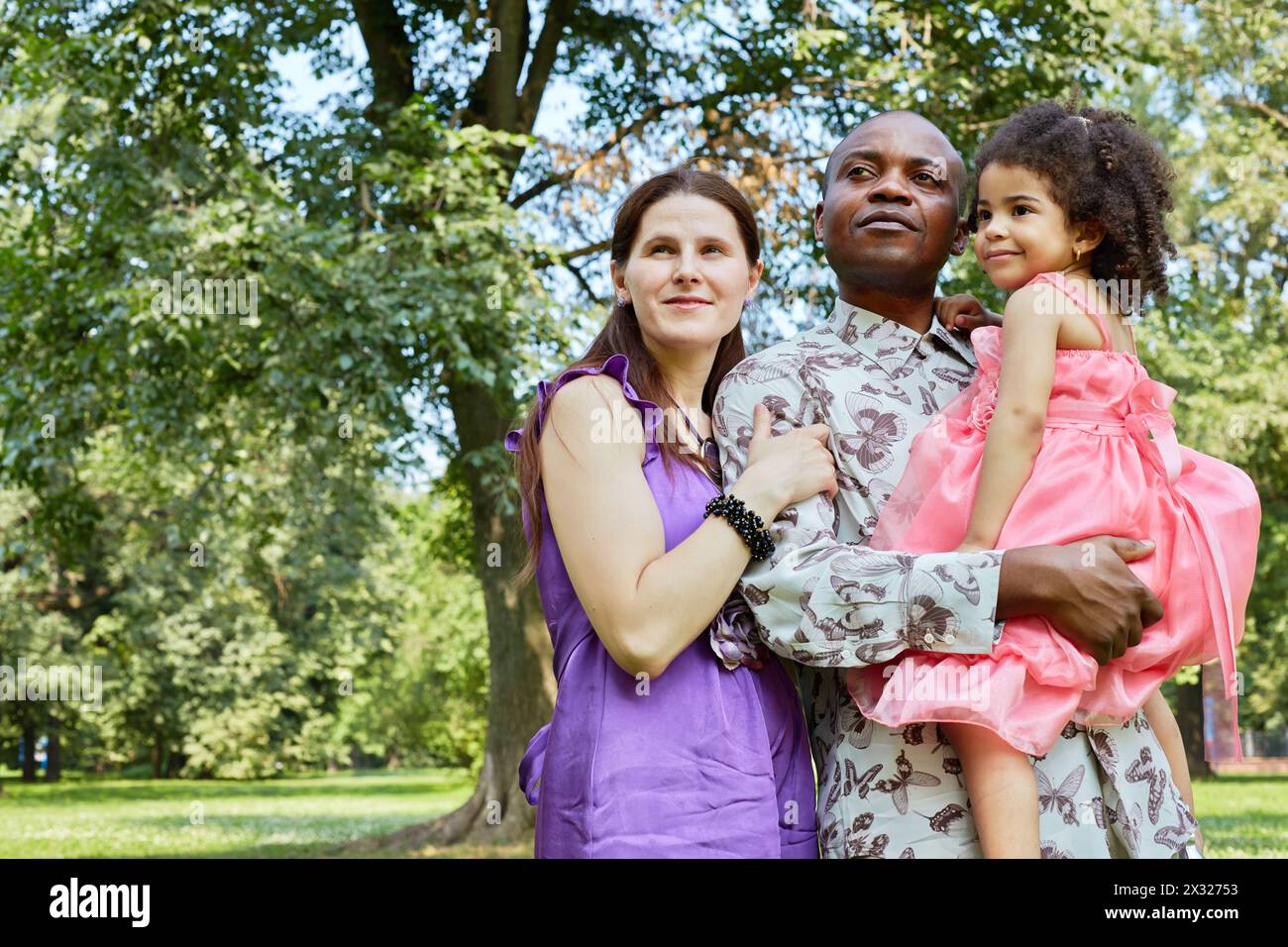 Portrait of white mother and african father, who holds little daughter ...