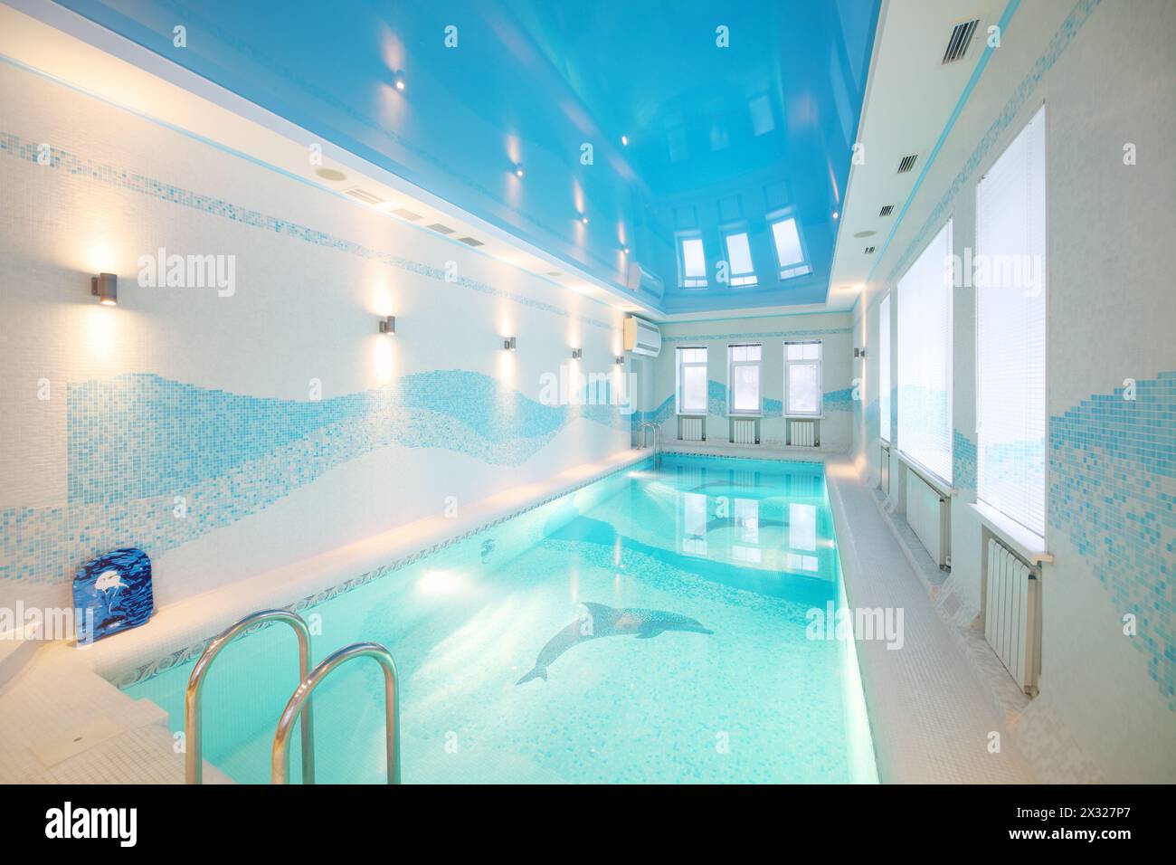 Indoor pool with images of dolphins at bottom and clear water in big ...
