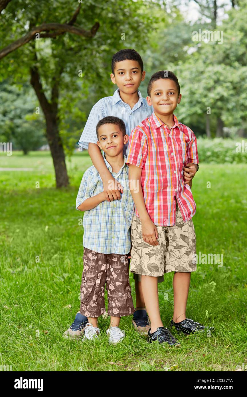 Three boys stand hi-res stock photography and images - Alamy