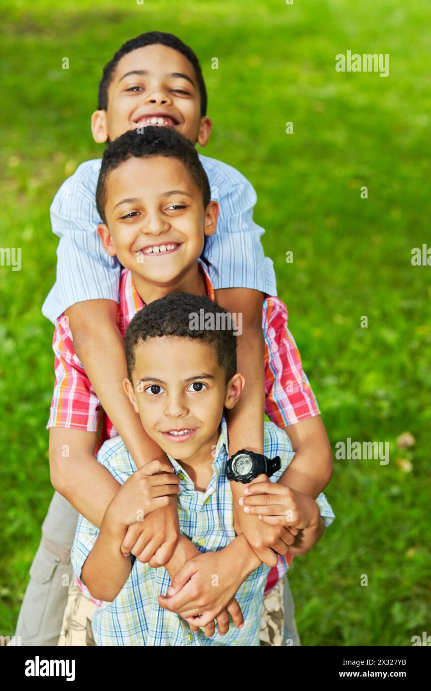 Half-length portrait of three boys-brothers who stand one by one ...