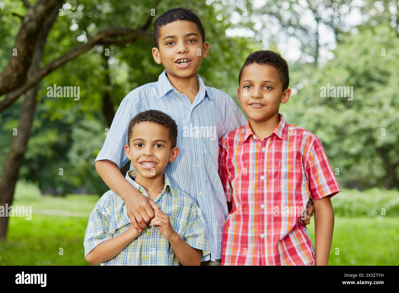 Half-length portrait of three boys-brothers who stand together in ...