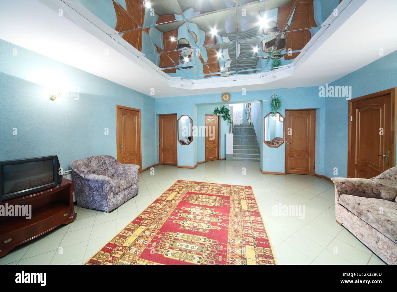 Hallway with chair, sofa, carpet on the floor and five doors Stock ...