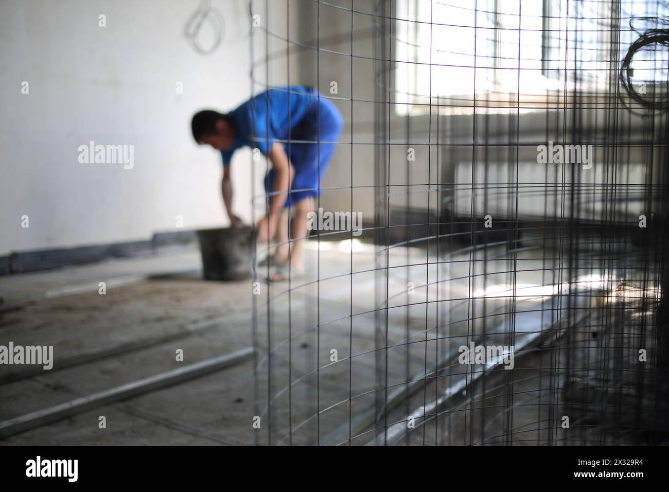 Mesh reinforcement in the room with the worker doing the repair Stock ...