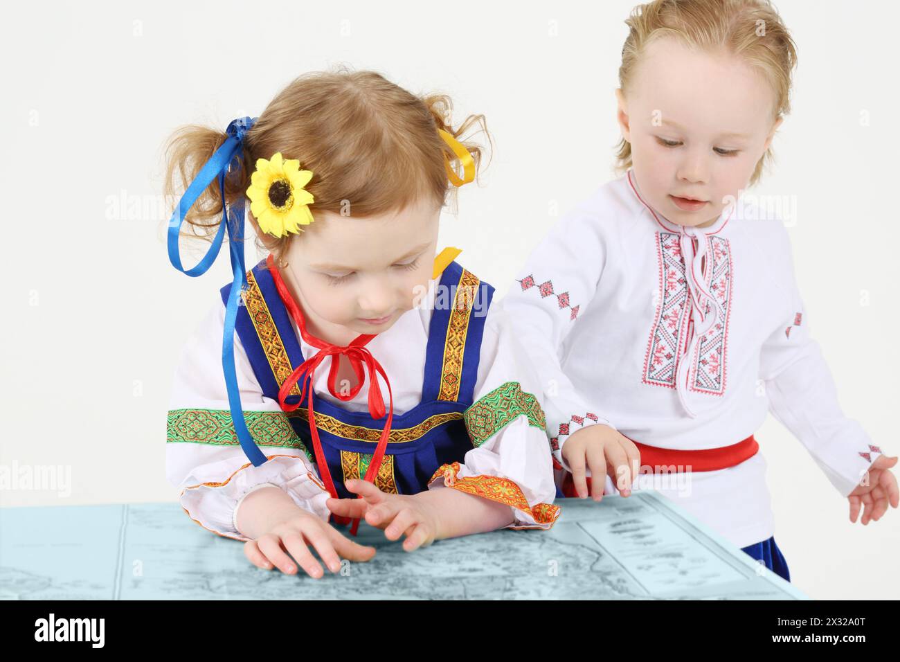 Little boy and girl in Russian national costume look at big map on ...