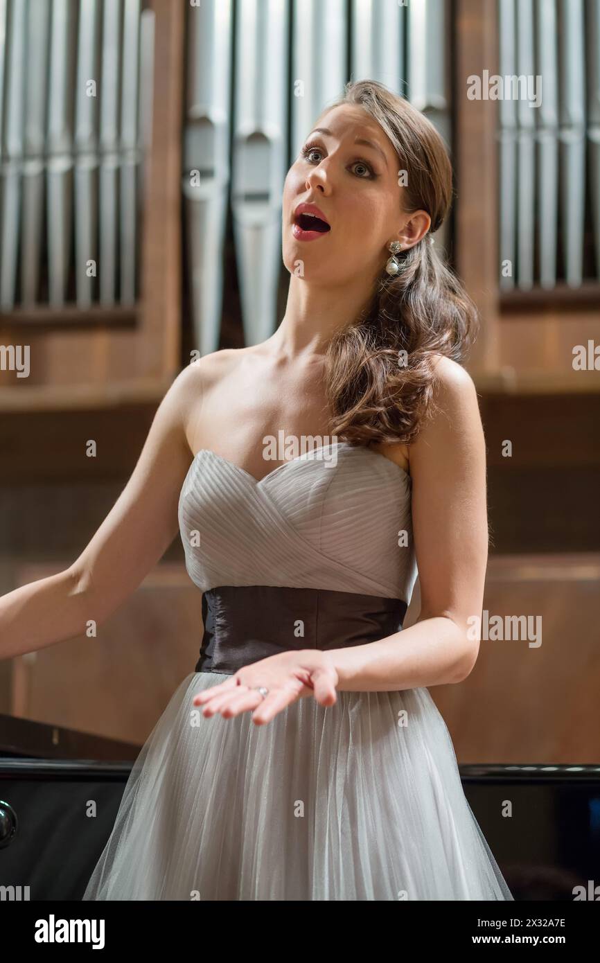 Beautiful opera singer sings in the concert hall Stock Photo - Alamy