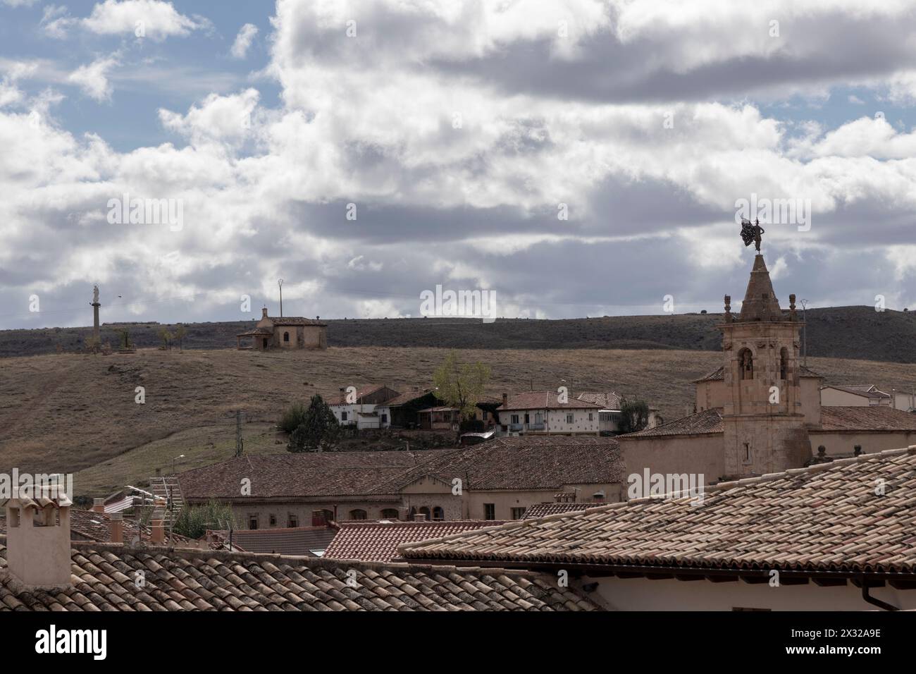 rustic village under a cloudy sky, highlighting architecture, nature's ...