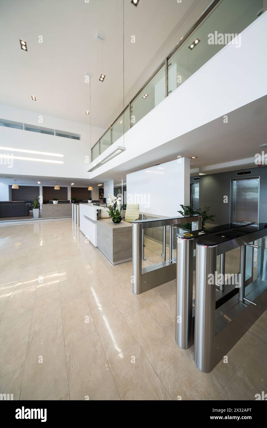 Security turnstiles and front desk at a business center in a modern ...