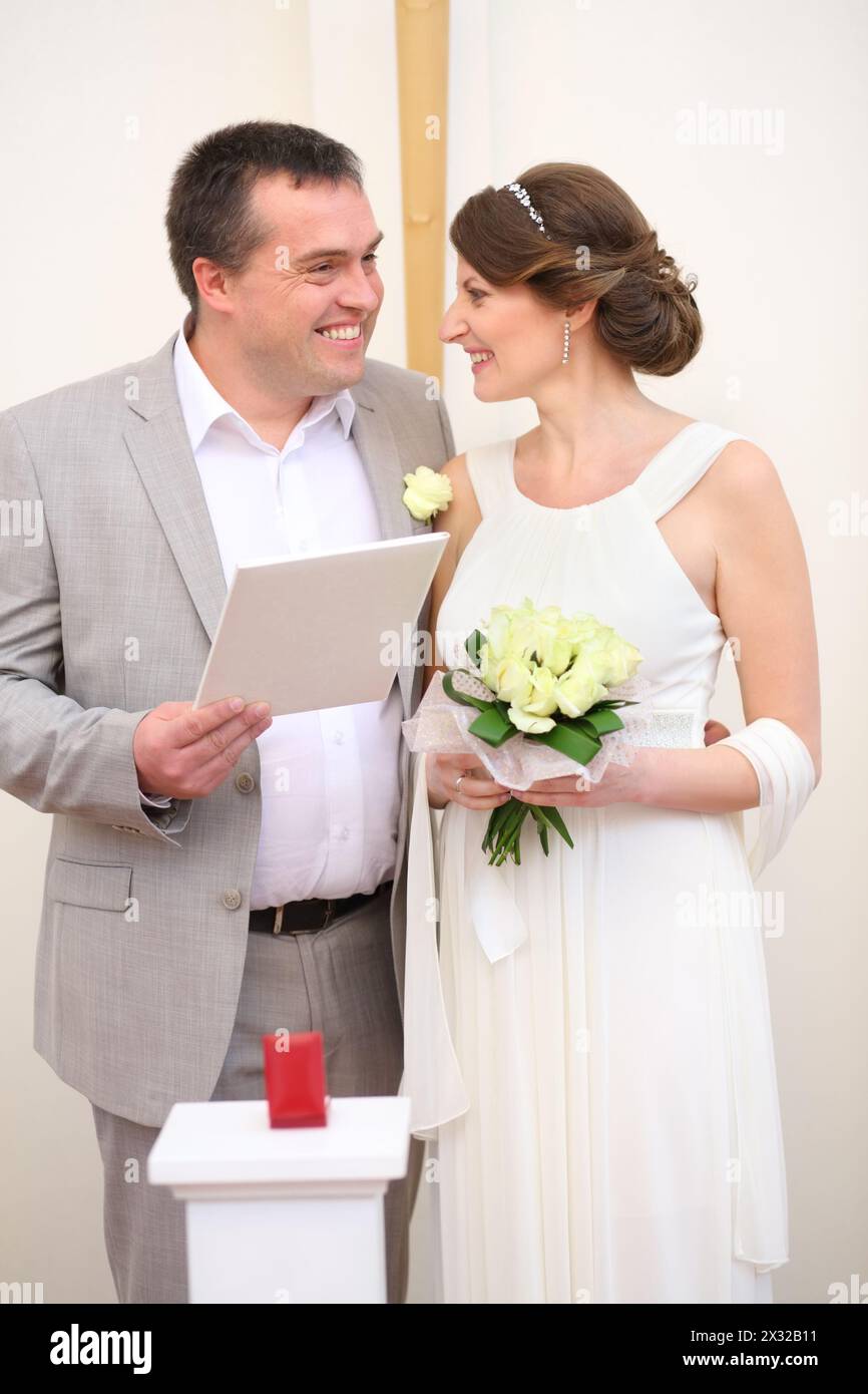 Happy newly wedding couple are holding a marriage certificate Stock ...
