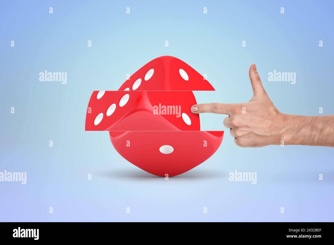 Finger pointing at a large red die Stock Photo - Alamy