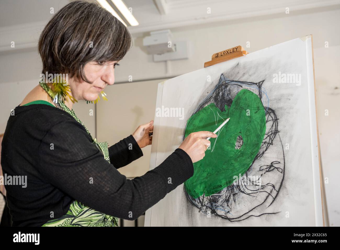 London, UK. 24 April 2024. Natalie Ryde, Fine Artist, makes a charcoal ...